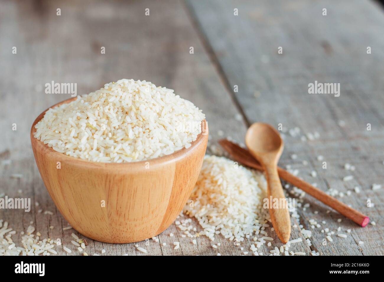 Rice on wooden floor Stock Photo - Alamy