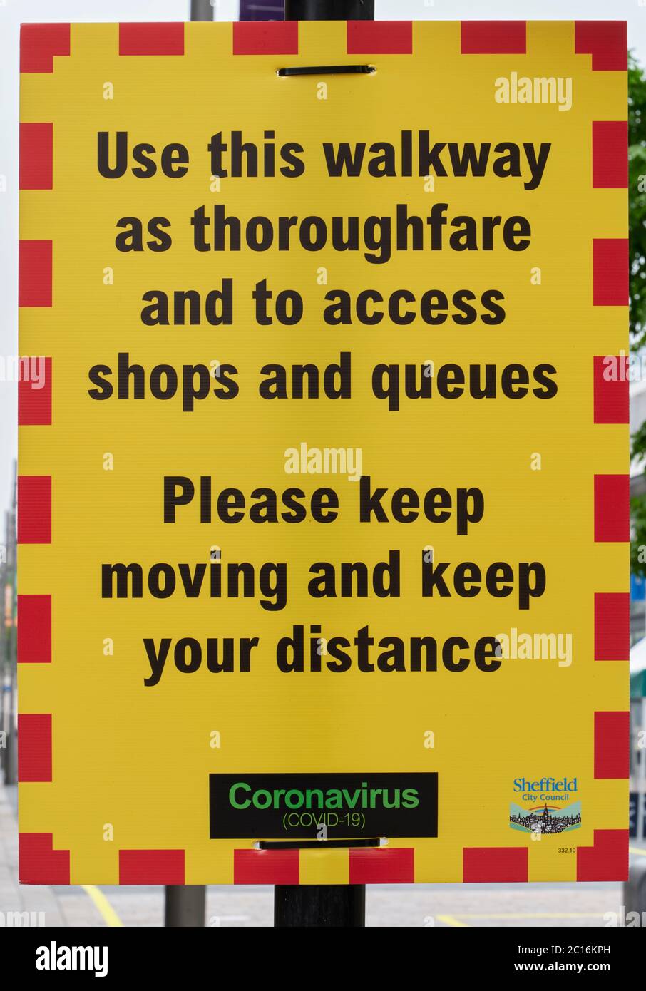 Signs and stickers on pavement to guide pedestrians along ...