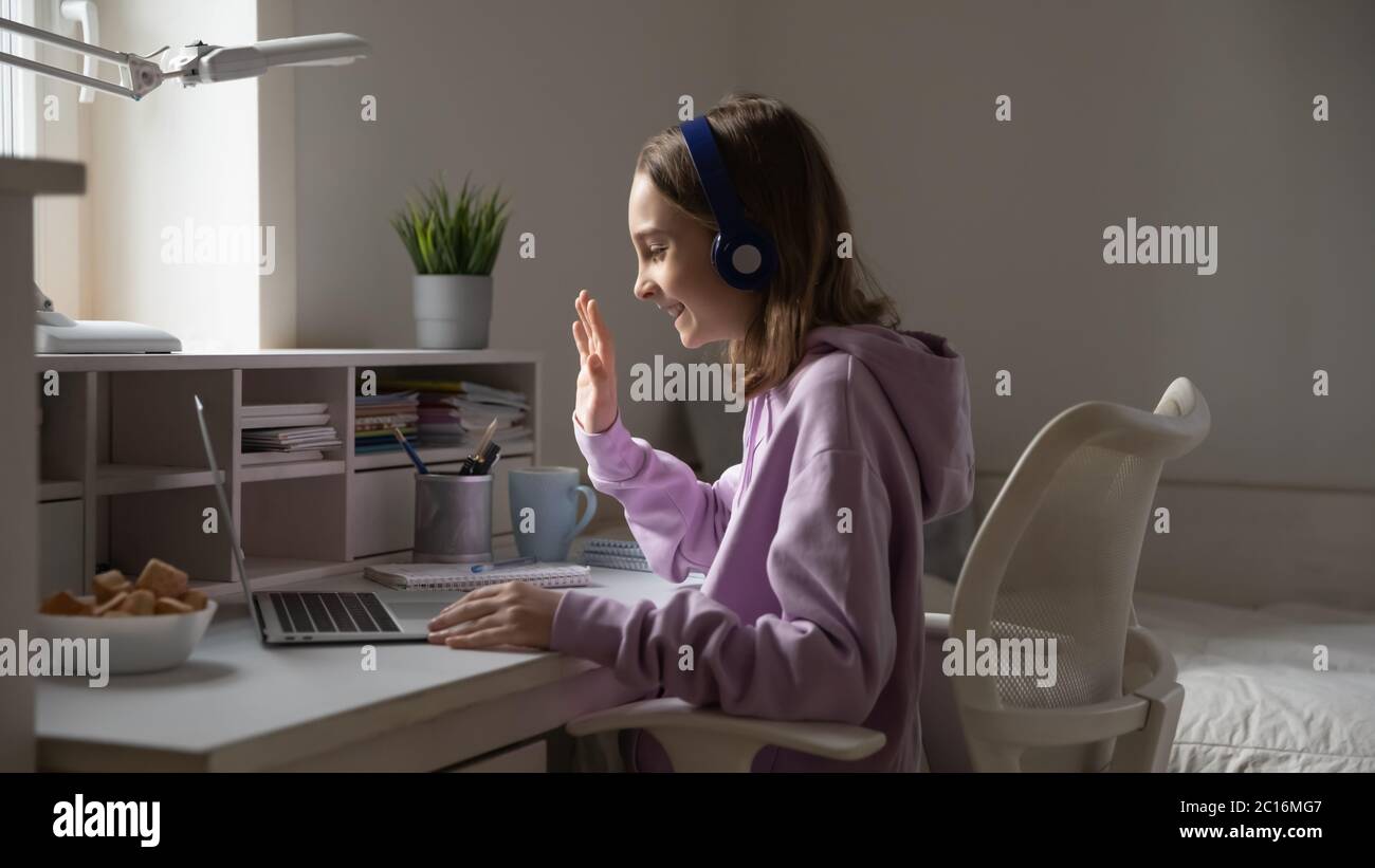 Smiling teenage girl have video call on laptop at home Stock Photo - Alamy