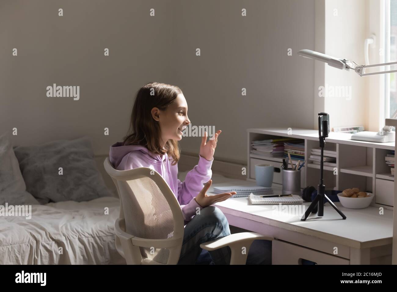 Teen girl shooting vlog on cellphone at home Stock Photo - Alamy