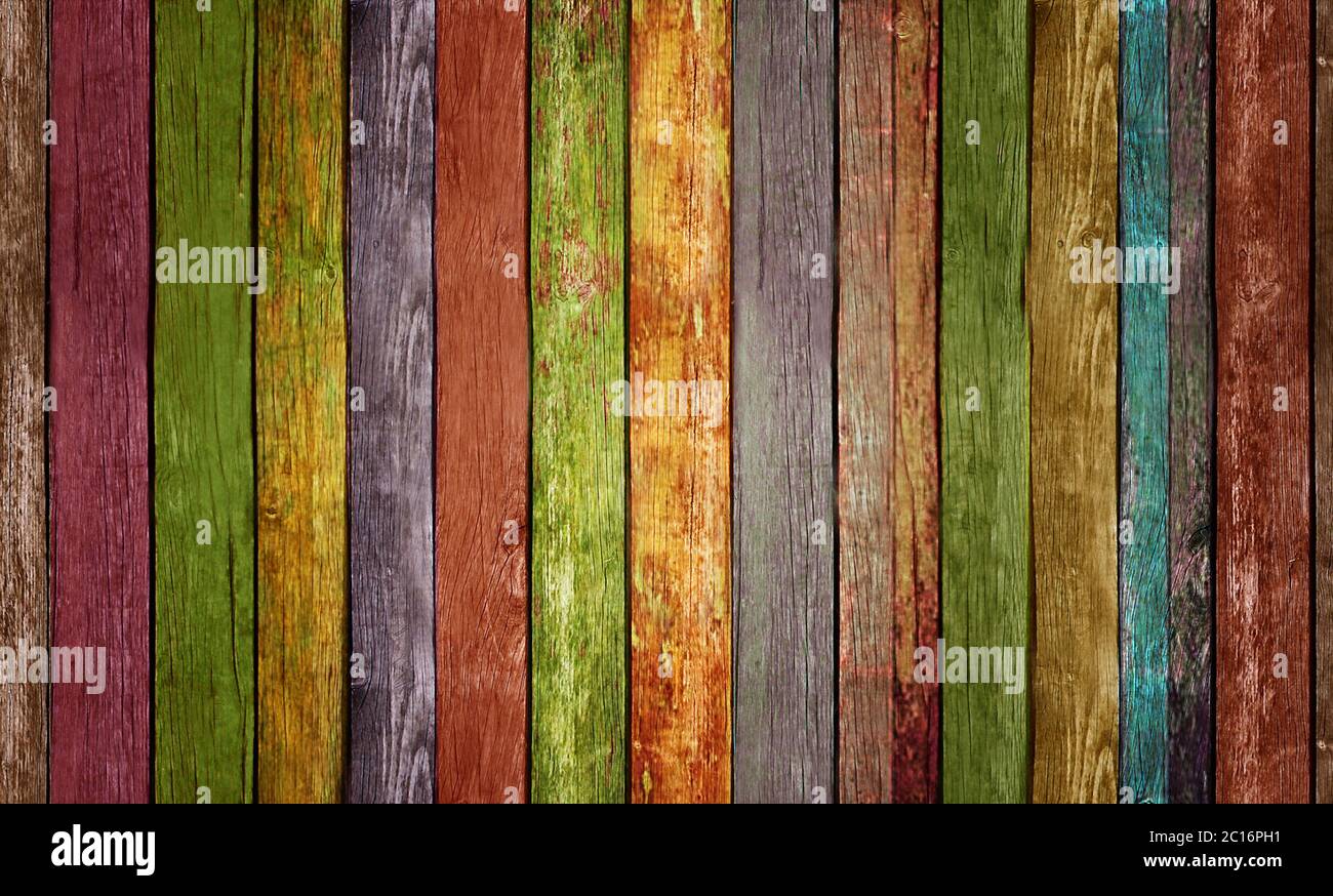 A wooden painted wall consisting of multicolored slats.Texture or ...