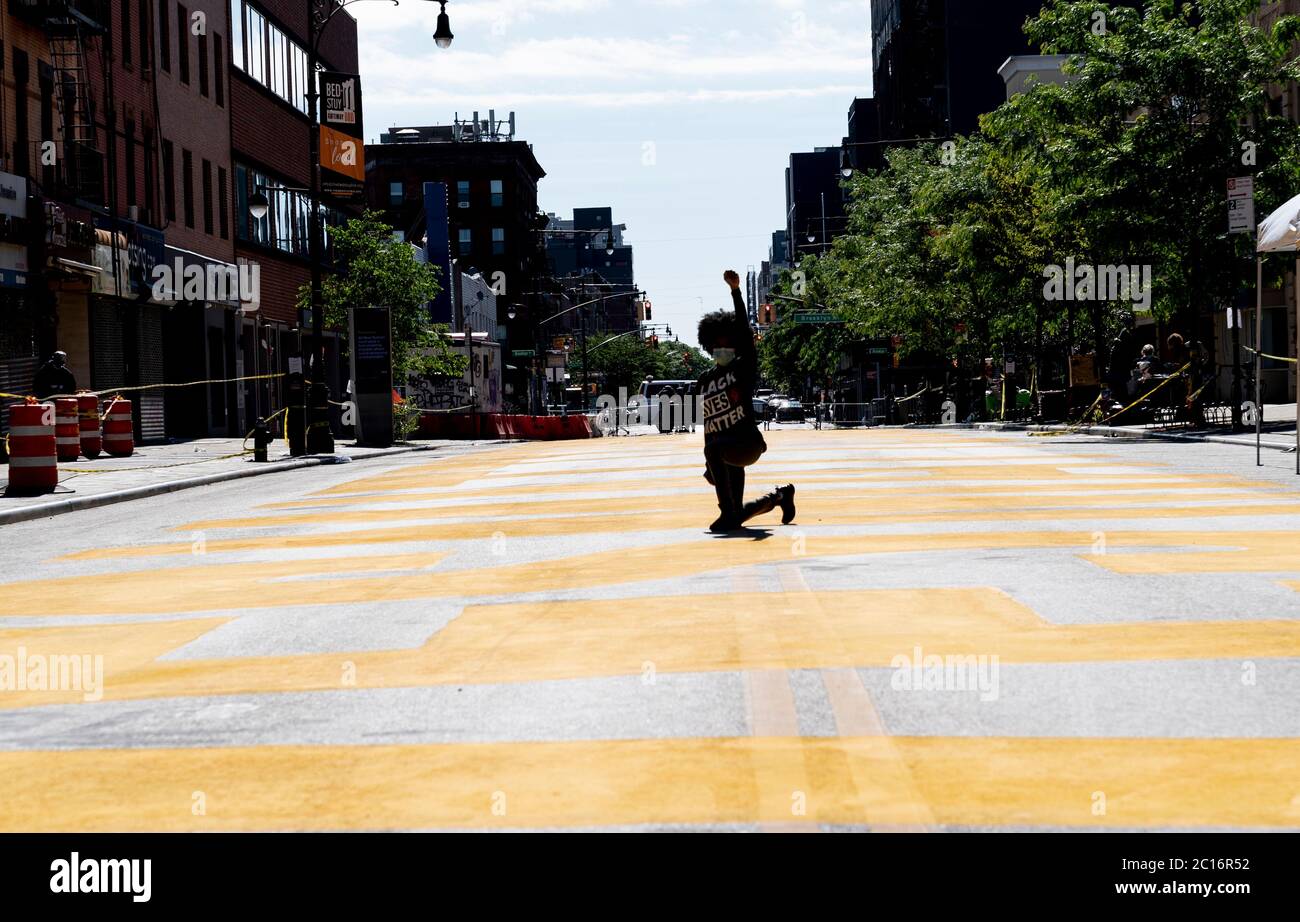 New York, NY - June 14, 2020: A woman wearing #BLM shirt poses with ...