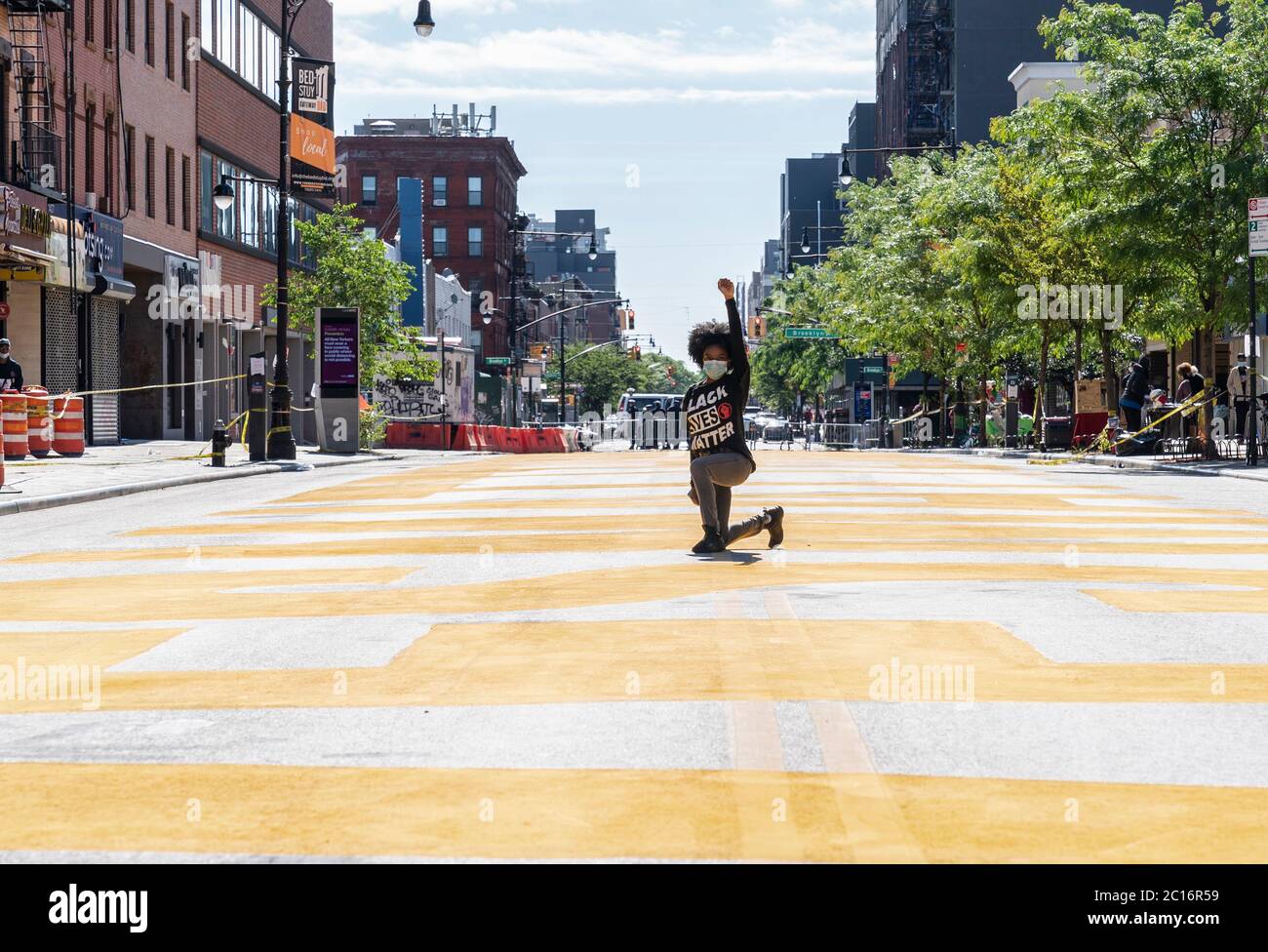 New York, NY - June 14, 2020: A woman wearing #BLM shirt poses with ...