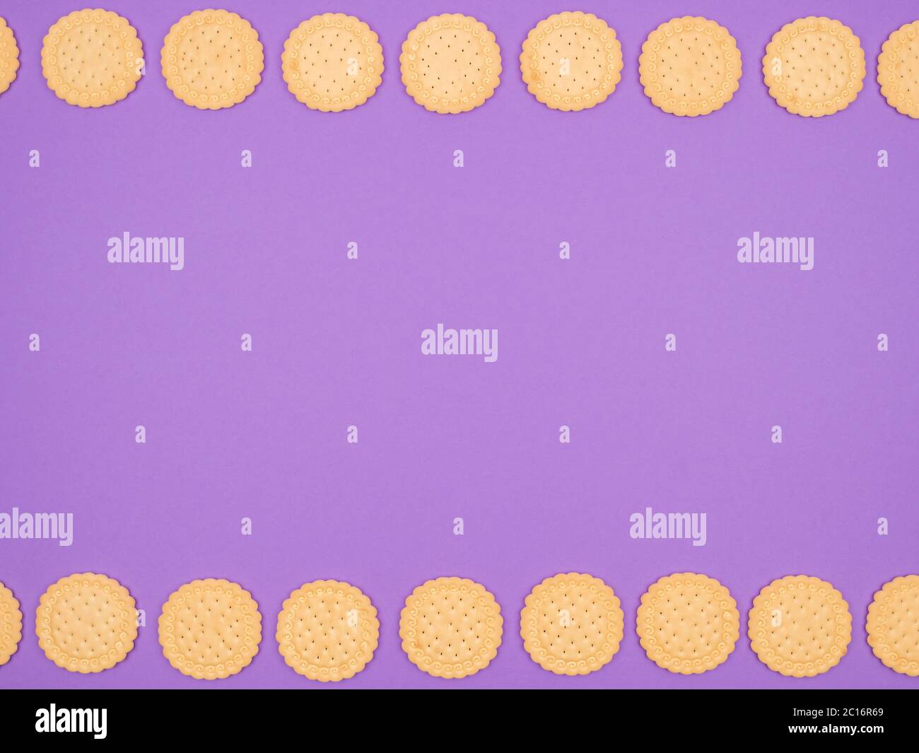 Round cookies on a purple background. Frame of pastries Stock Photo - Alamy