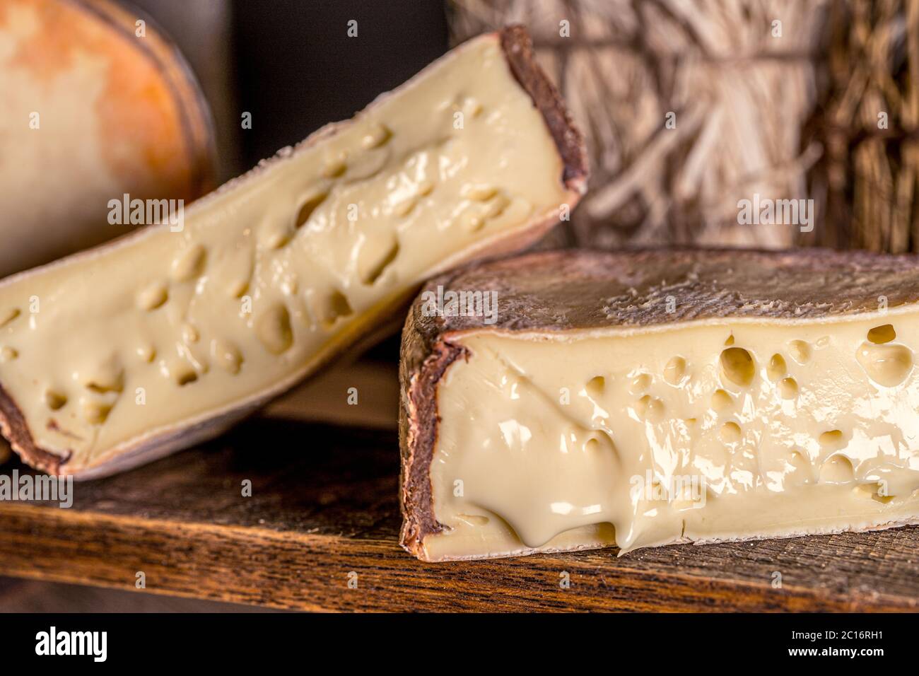 French cheese Saint Nectaire rustic collection delicious. Black ...