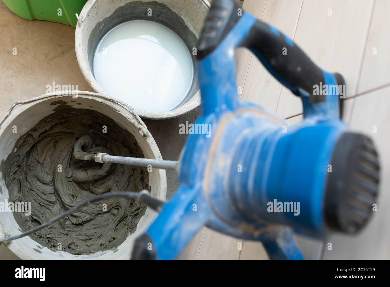 A full bucket of special tile adhesive ready for use. Dense cement ...