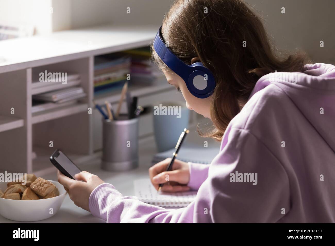 Teenage girl study at home using smartphone gadget Stock Photo - Alamy