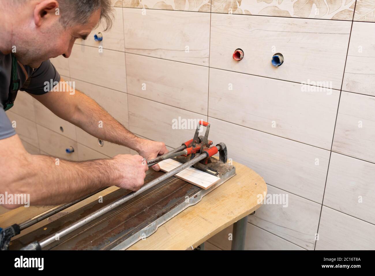 Tile cutting machine. Construction worker. Precise cutting of ceramic ...