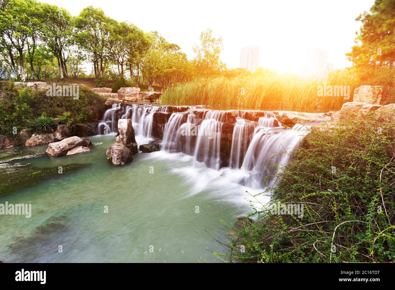 beautiful waterfall with sunbeam Stock Photo - Alamy