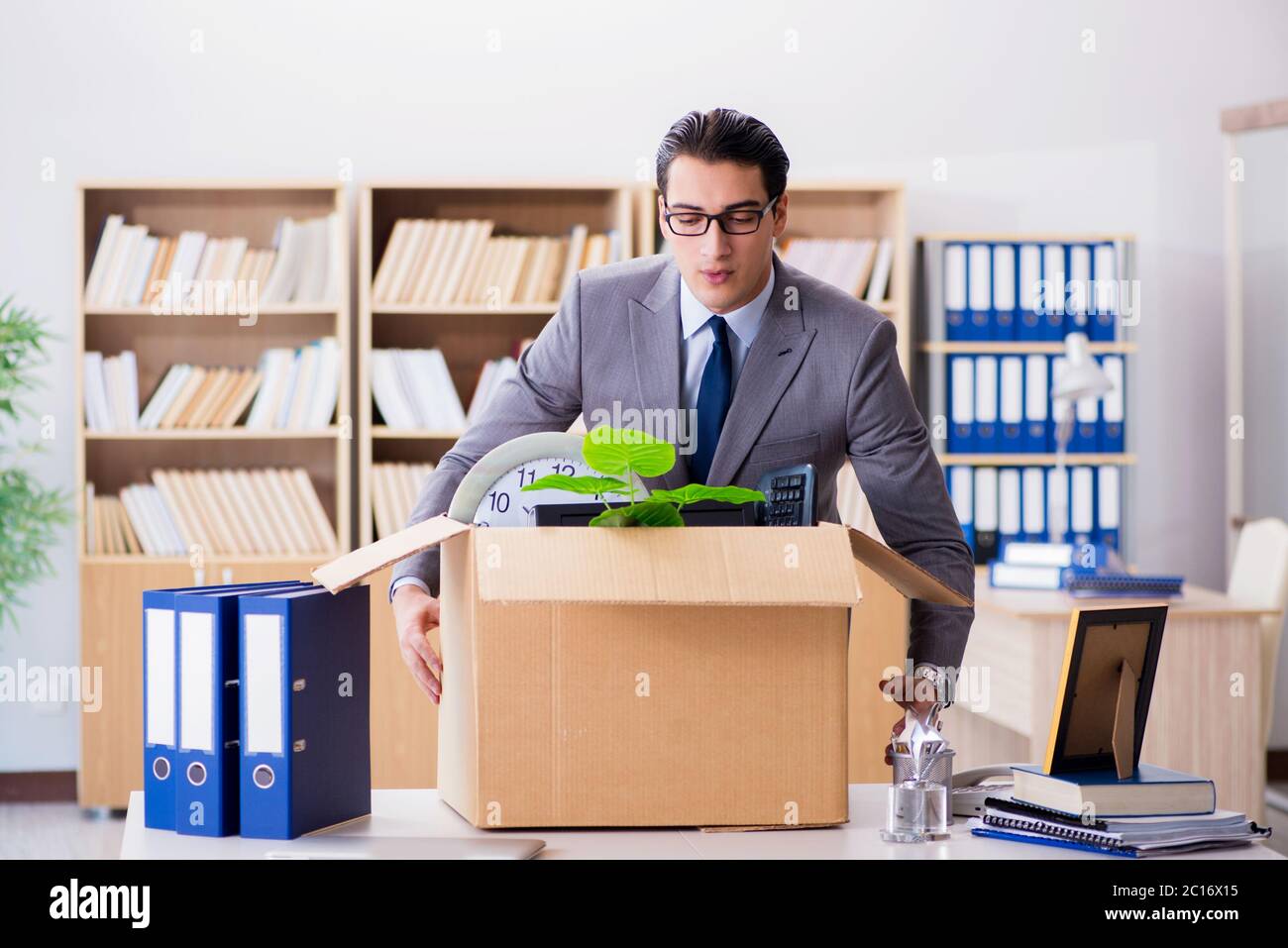 Man moving office with box and his belongings Stock Photo - Alamy