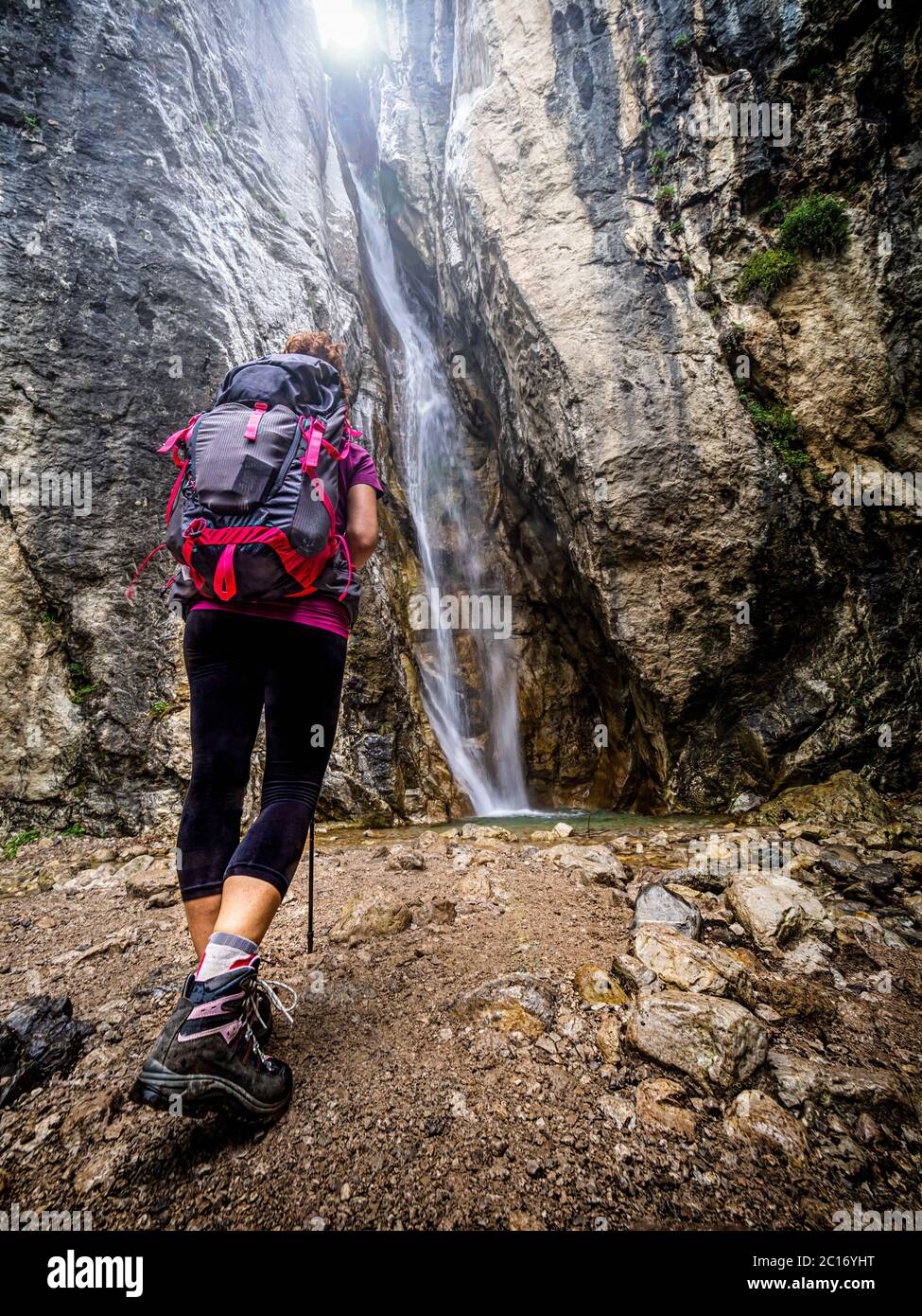 Hiker girl under a waterfall in the Italian alps Stock Photo - Alamy