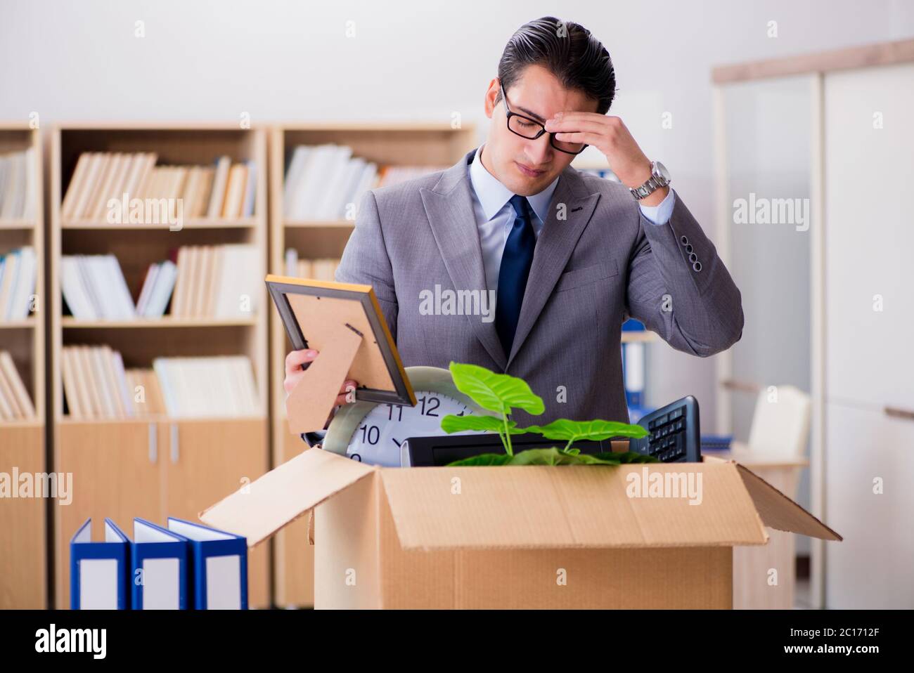 Man moving office with box and his belongings Stock Photo - Alamy