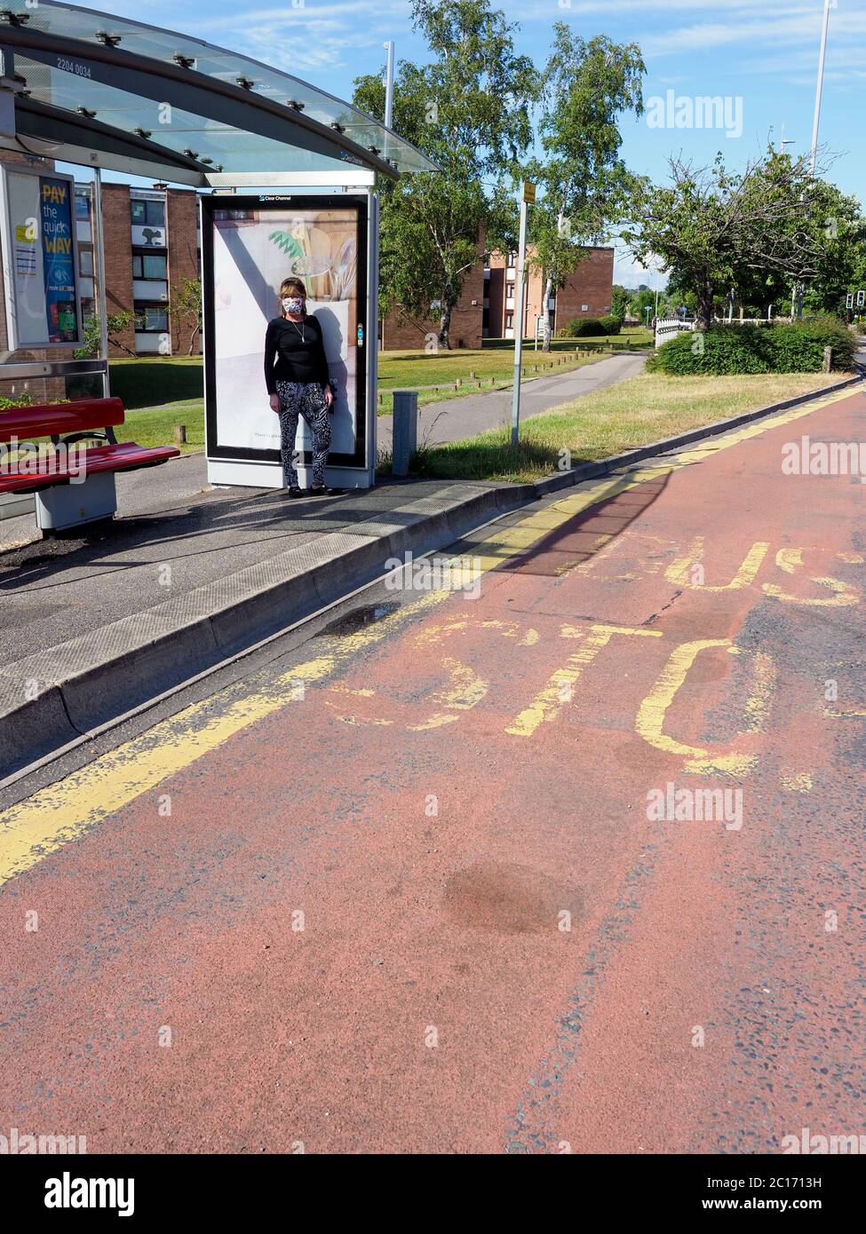 Wearing face mask at bus stop hi-res stock photography and images - Alamy