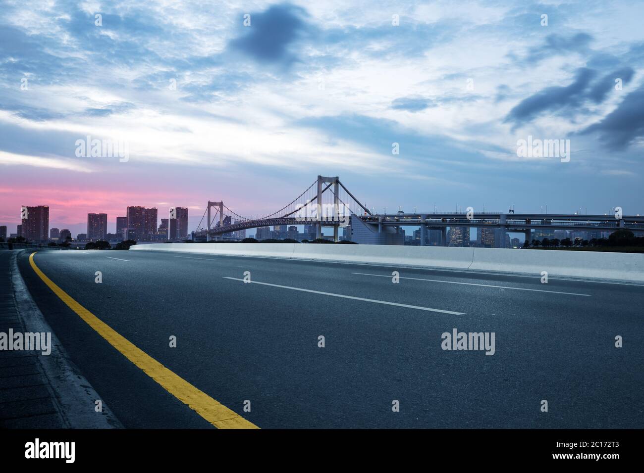 empty road with suspension bridge in modern city Stock Photo - Alamy
