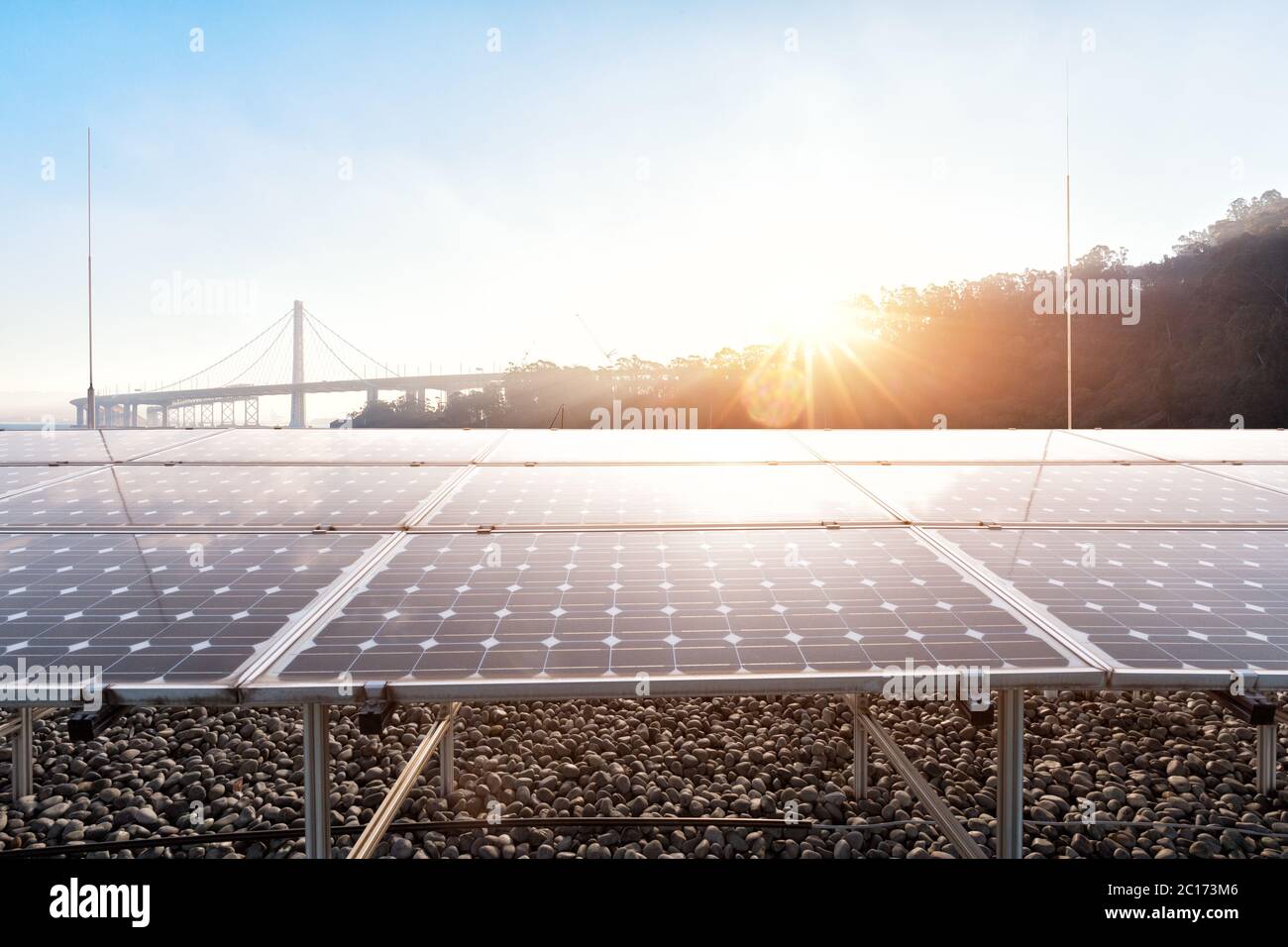 solar panels near modern suspension bridge with sunbeam Stock Photo - Alamy