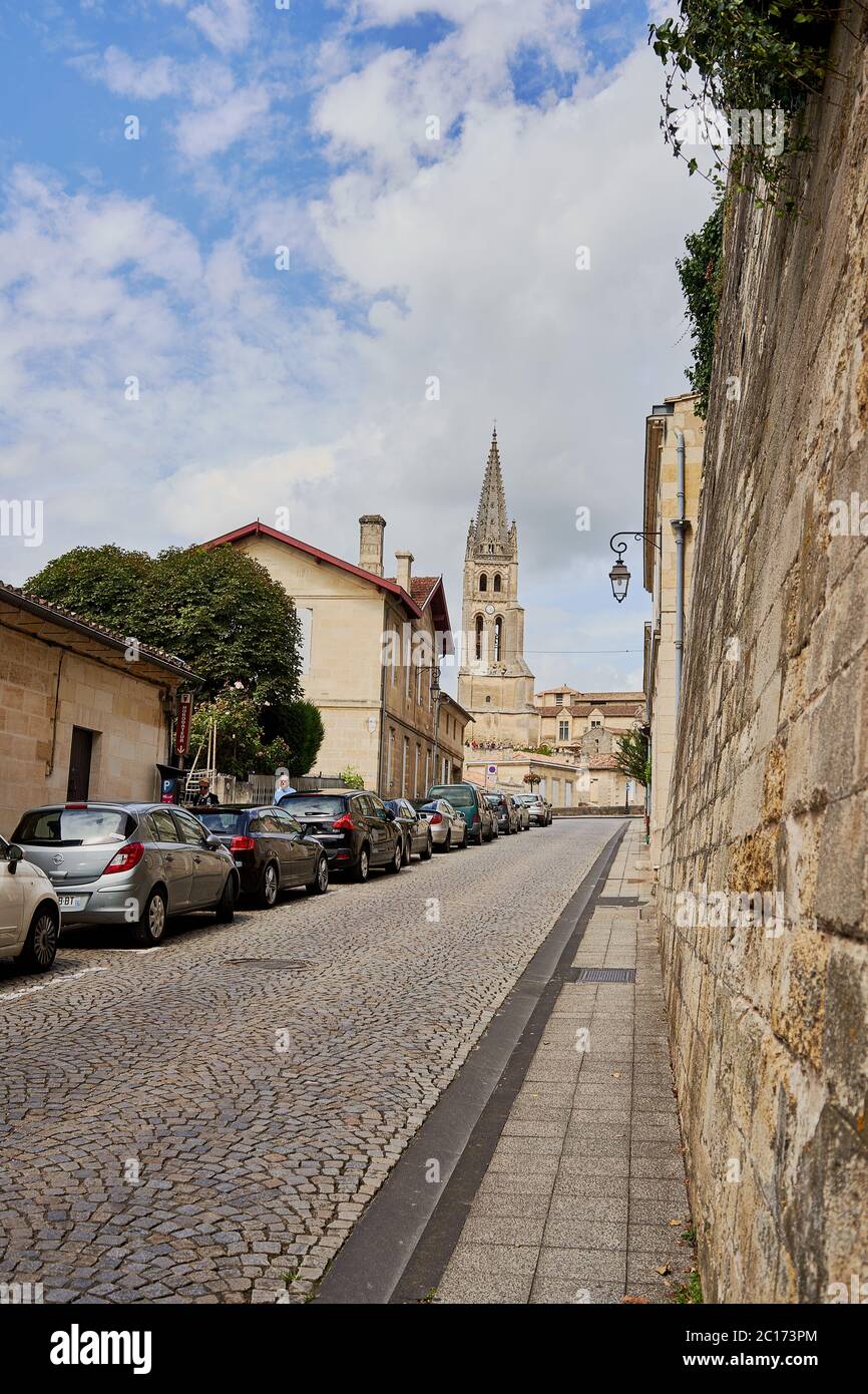 A view up a street line with cars to the Belltower of the Monolithic ...