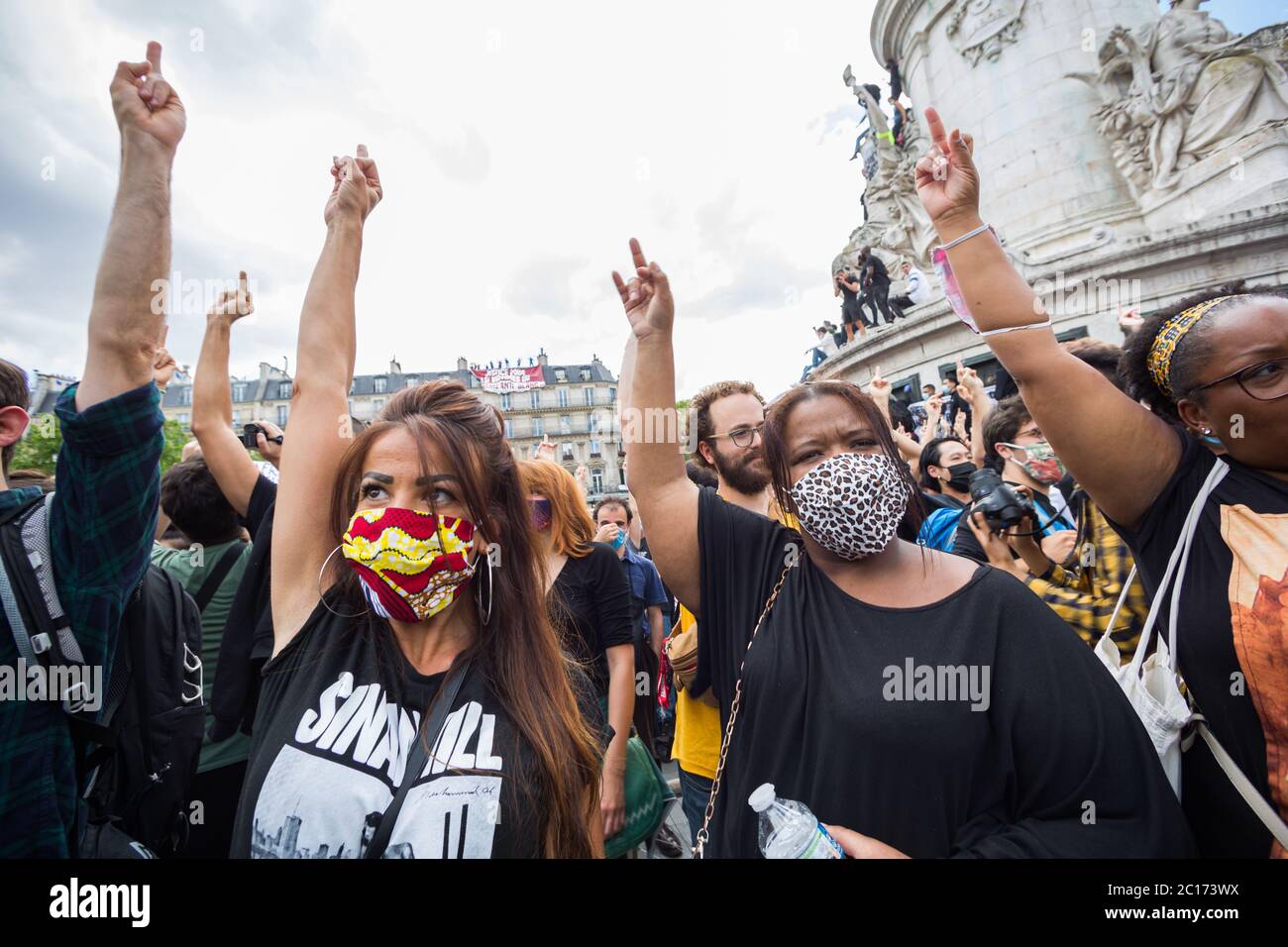 Paris, France. 13th June, 2020. Protesters turn their backs and give ...