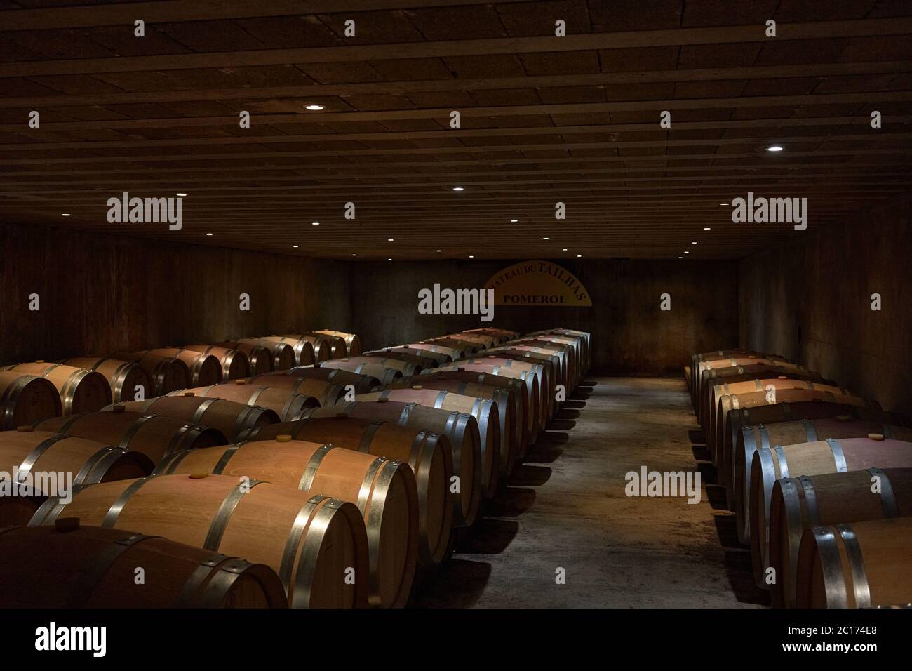 Oak Wine barrels in storage at Chateau De Tailhas in the Pomerol ...