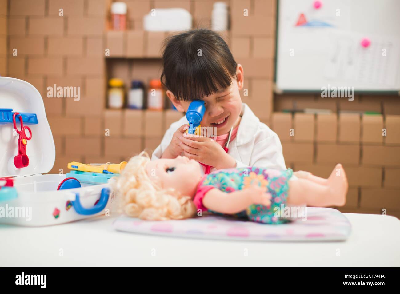 toddler girl pretend play doctor role at home Stock Photo - Alamy