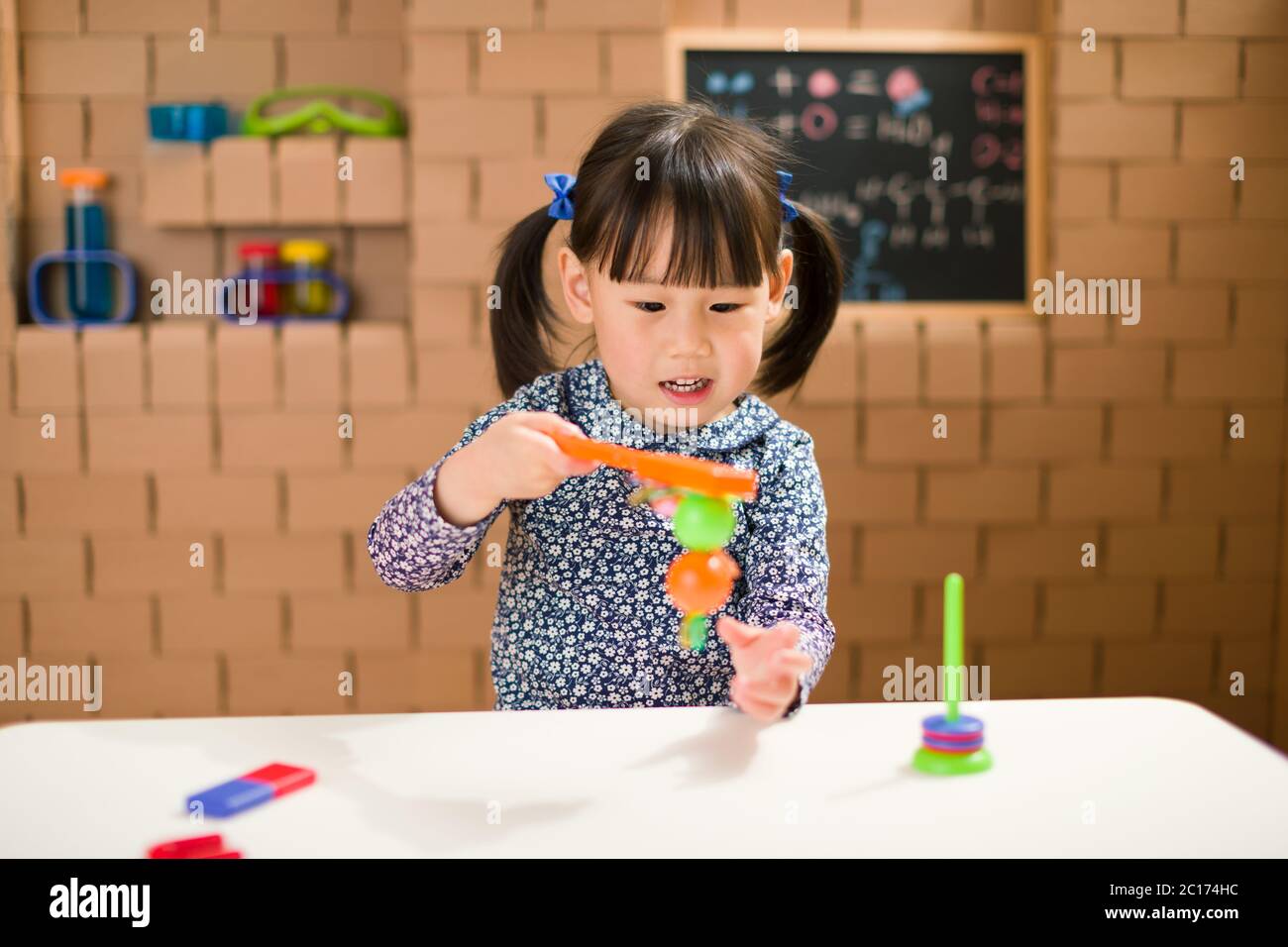 toddler girl play magical magnet experiments at home for homeschooling ...