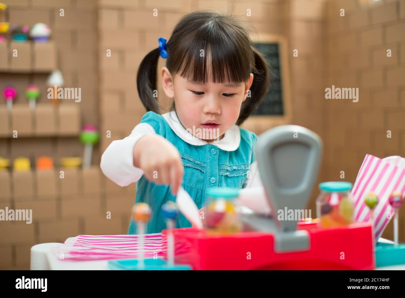 toddler girl pretend play sweet shop keeper at home Stock Photo - Alamy