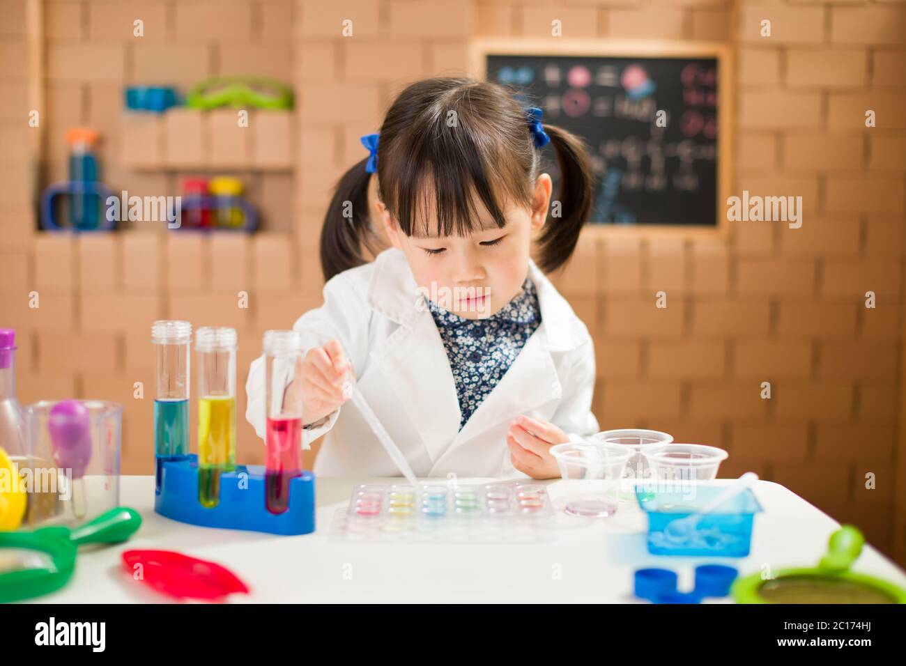 toddler girl pretend play scientist role for homeschooling Stock Photo ...
