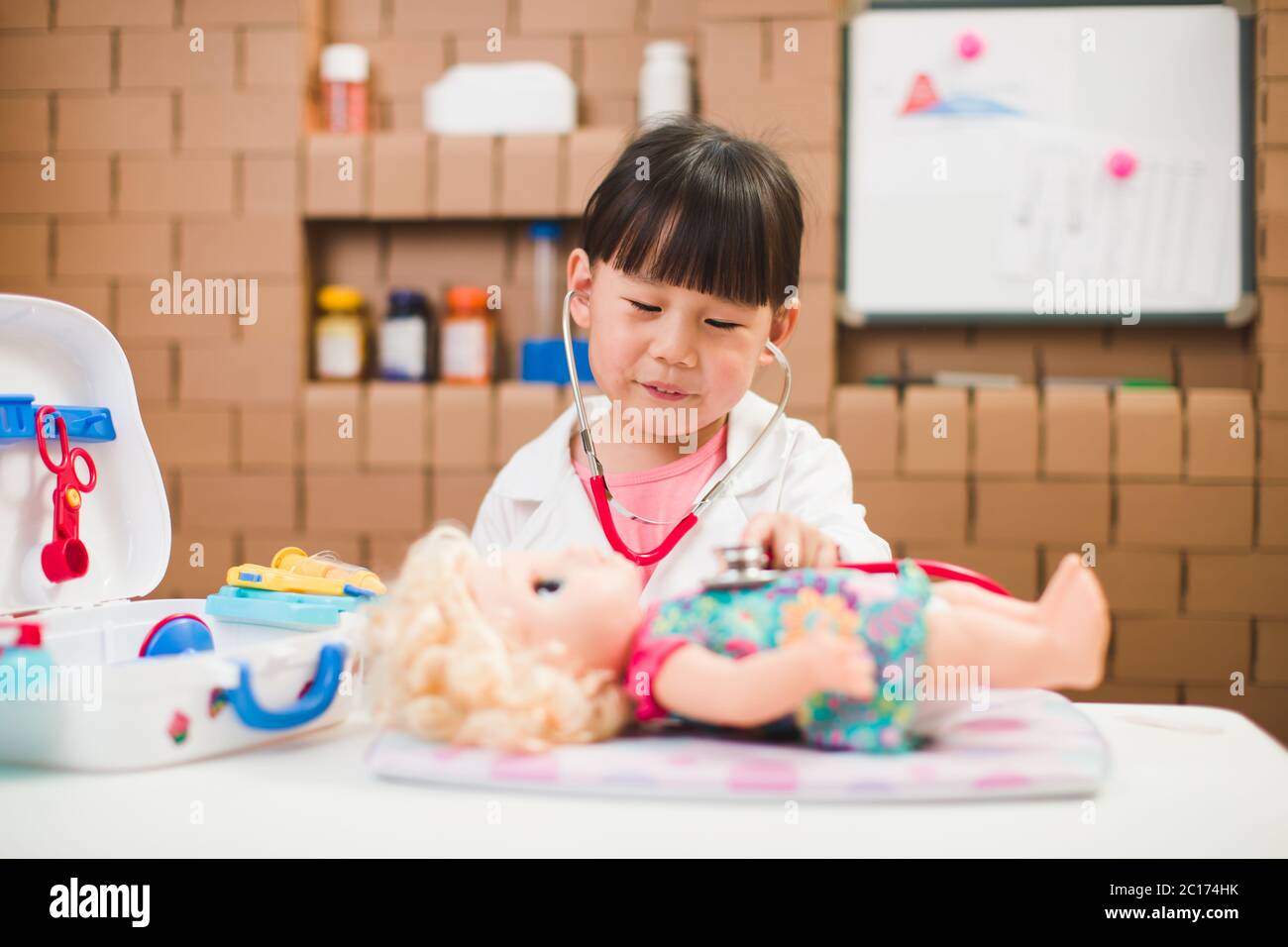 toddler girl pretend play doctor role at home Stock Photo - Alamy
