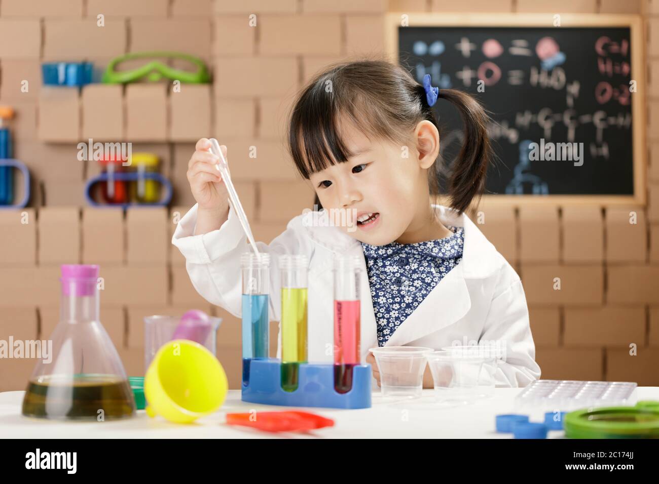 toddler girl pretend play scientist role for homeschooling Stock Photo ...