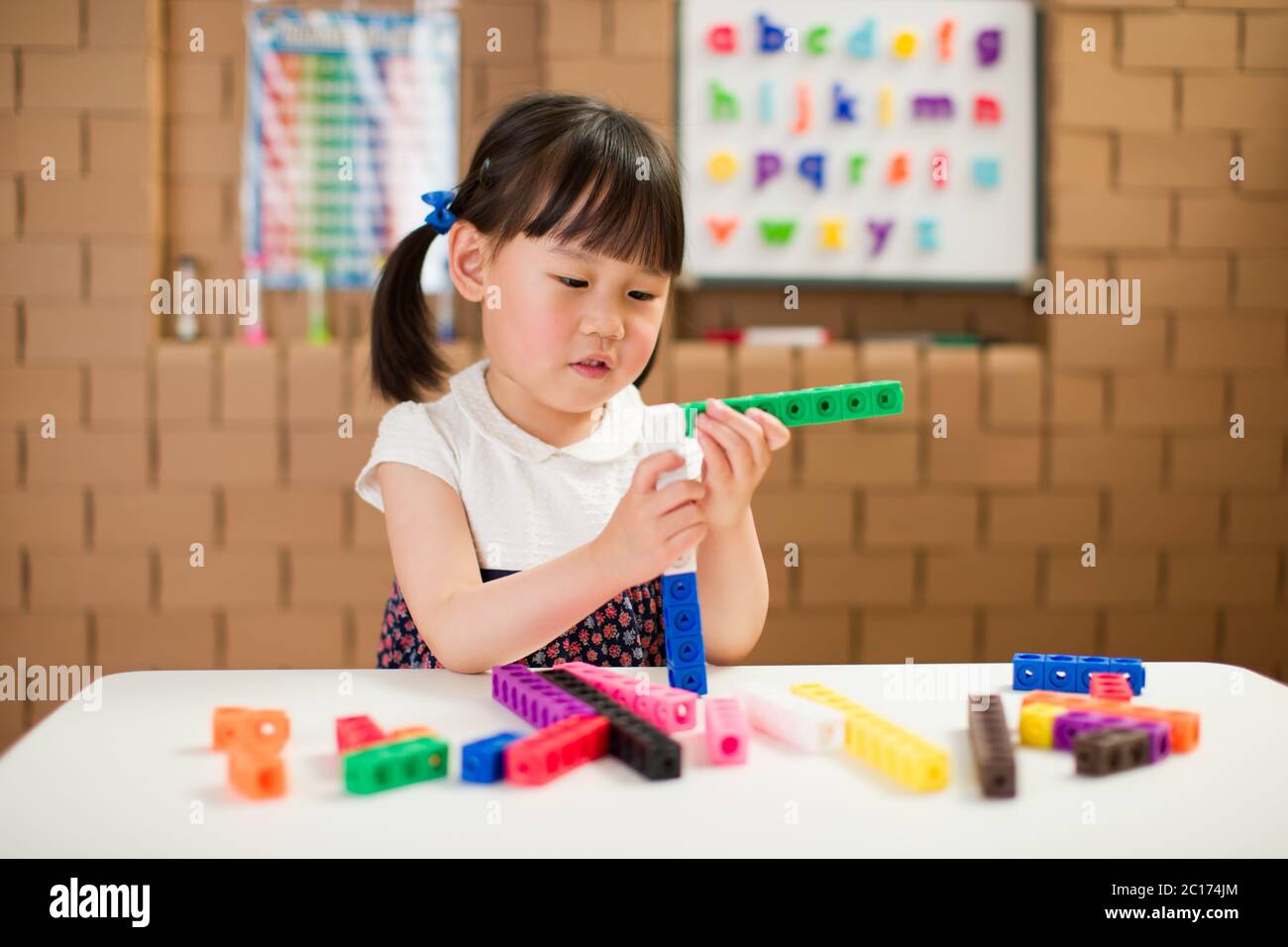 toddler girl play number blocks for homeschooling Stock Photo - Alamy