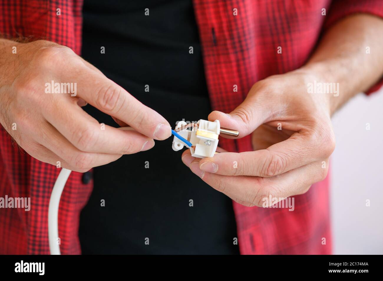 Male hands connect wires to extension plug Stock Photo - Alamy