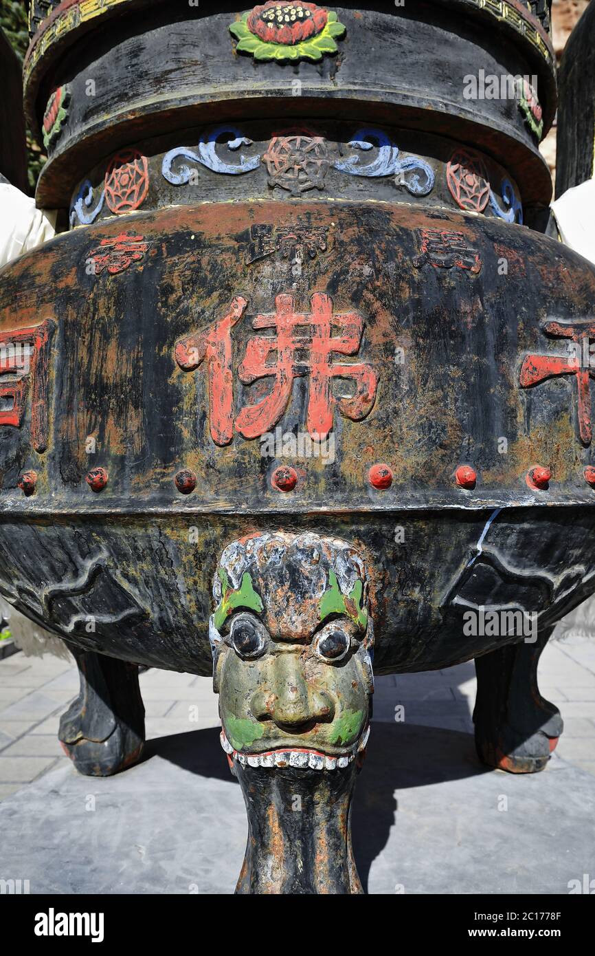 Large iron censer-human faced leg resting on tongue. Qianfo Grottoes ...