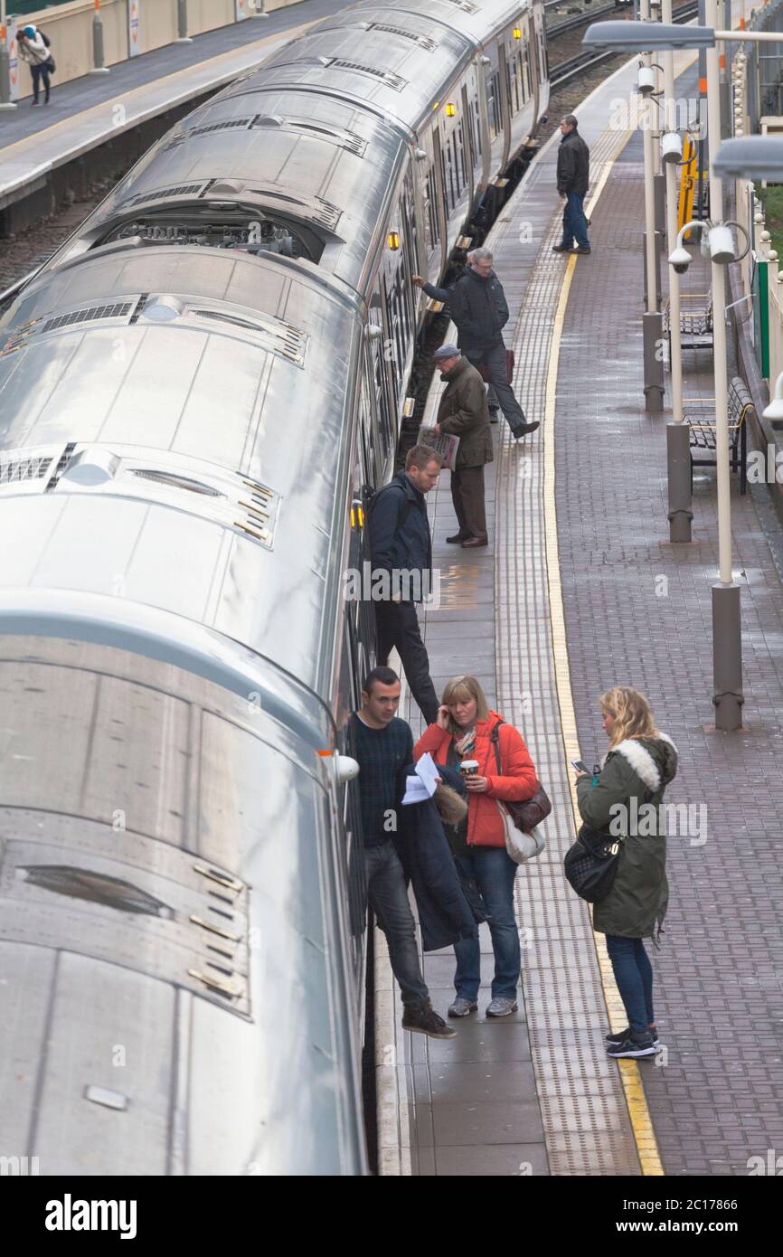 Passengers boarding and alighting from a London Overground train at ...