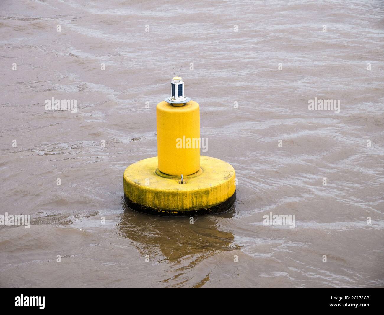 Yellow buoy floating on water Stock Photo - Alamy
