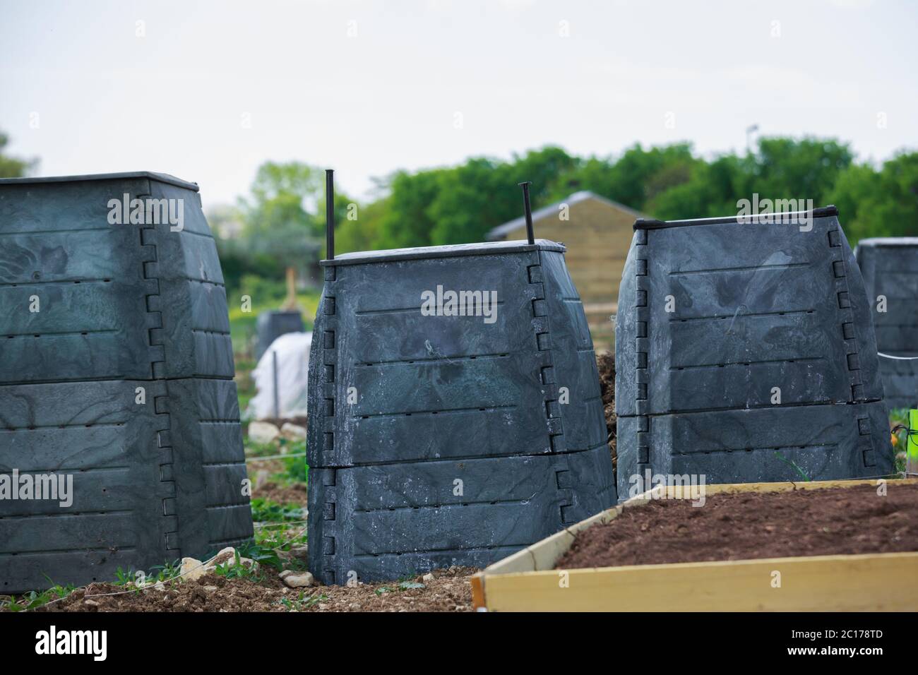 Black plastic compost bin in town garden Stock Photo - Alamy
