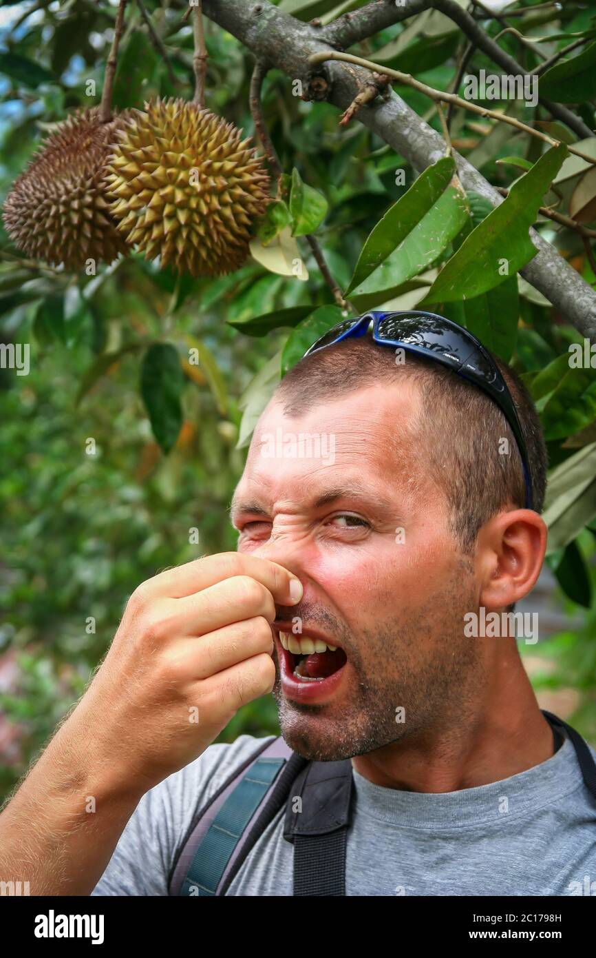 Smelling durian fruit Stock Photo - Alamy
