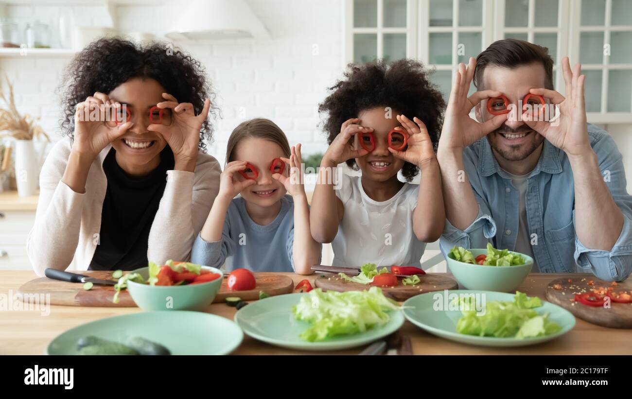Family cooking together having fun covering eyes with red paprika Stock ...