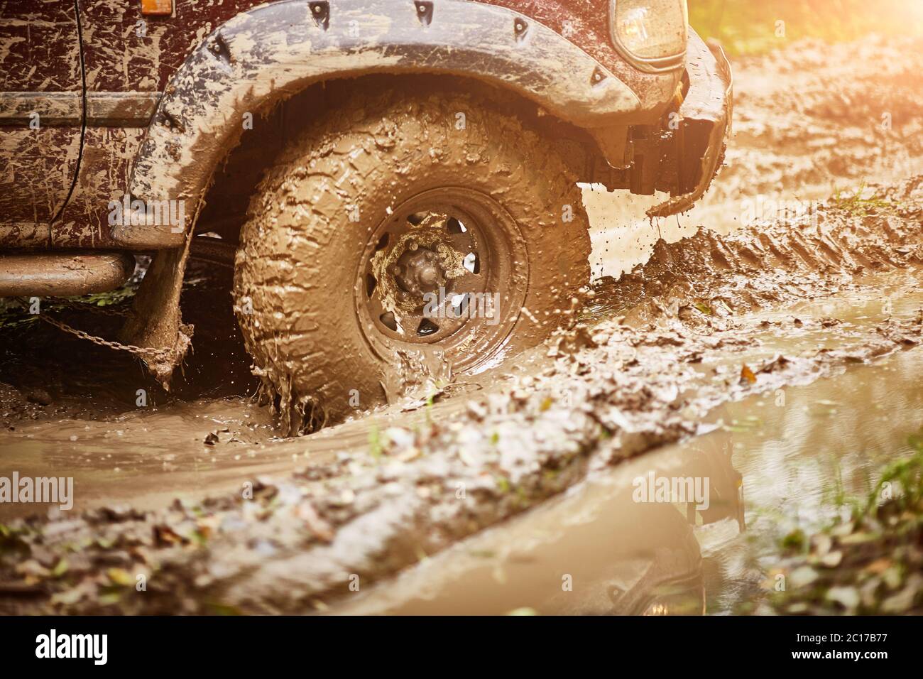 moving dirty off-road car tire in mud close-up Stock Photo - Alamy