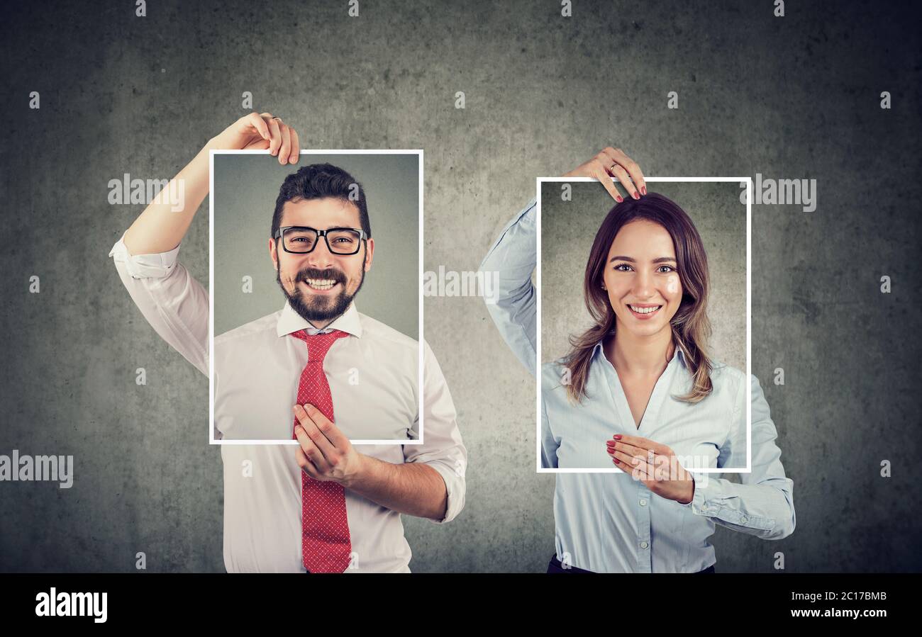 Happy young man and woman holding self portraits Stock Photo - Alamy
