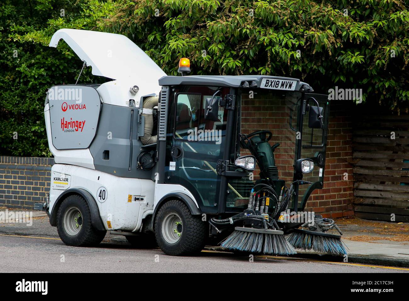 A road cleaning vehicle seen parked on the street Stock Photo - Alamy