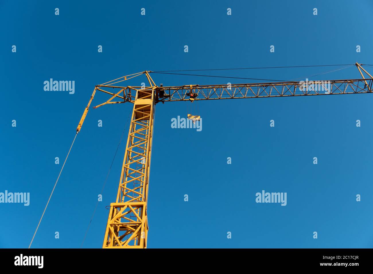 Isolated construction crane with clear blue sky background Stock Photo ...