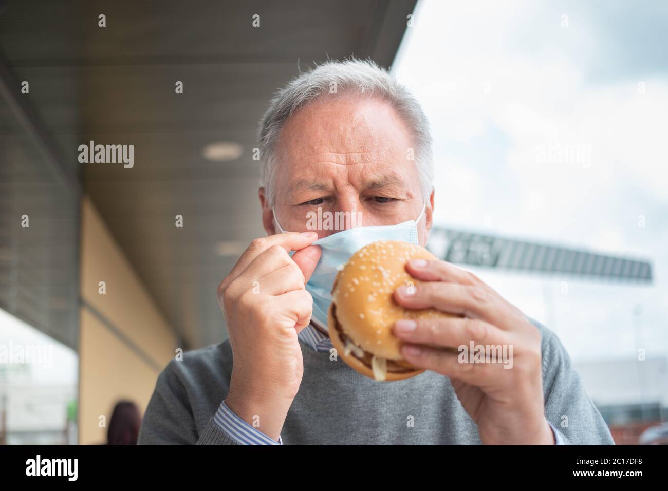 Funny man eating hamburger hi-res stock photography and images - Alamy