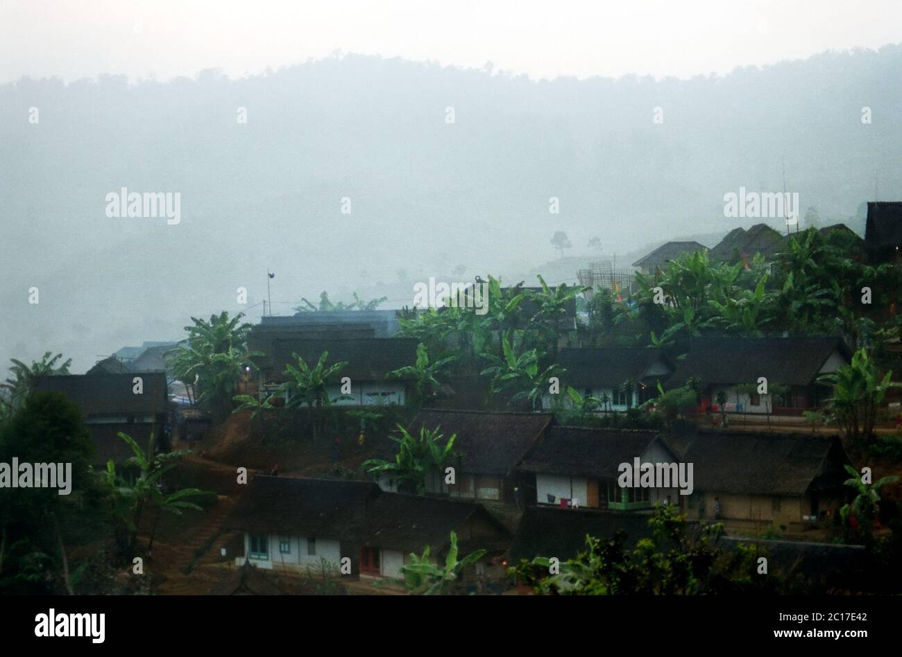 Traditional houses on the slope of a hill in the indigenous village of ...