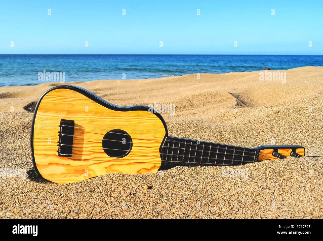 Guitar on the Sand Beach Stock Photo - Alamy