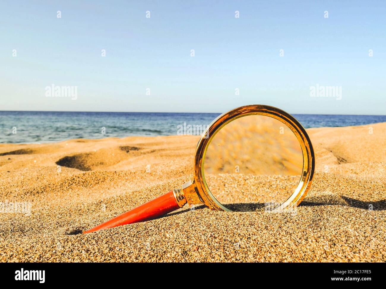 Magnify Glass on the Sand Beach Stock Photo - Alamy