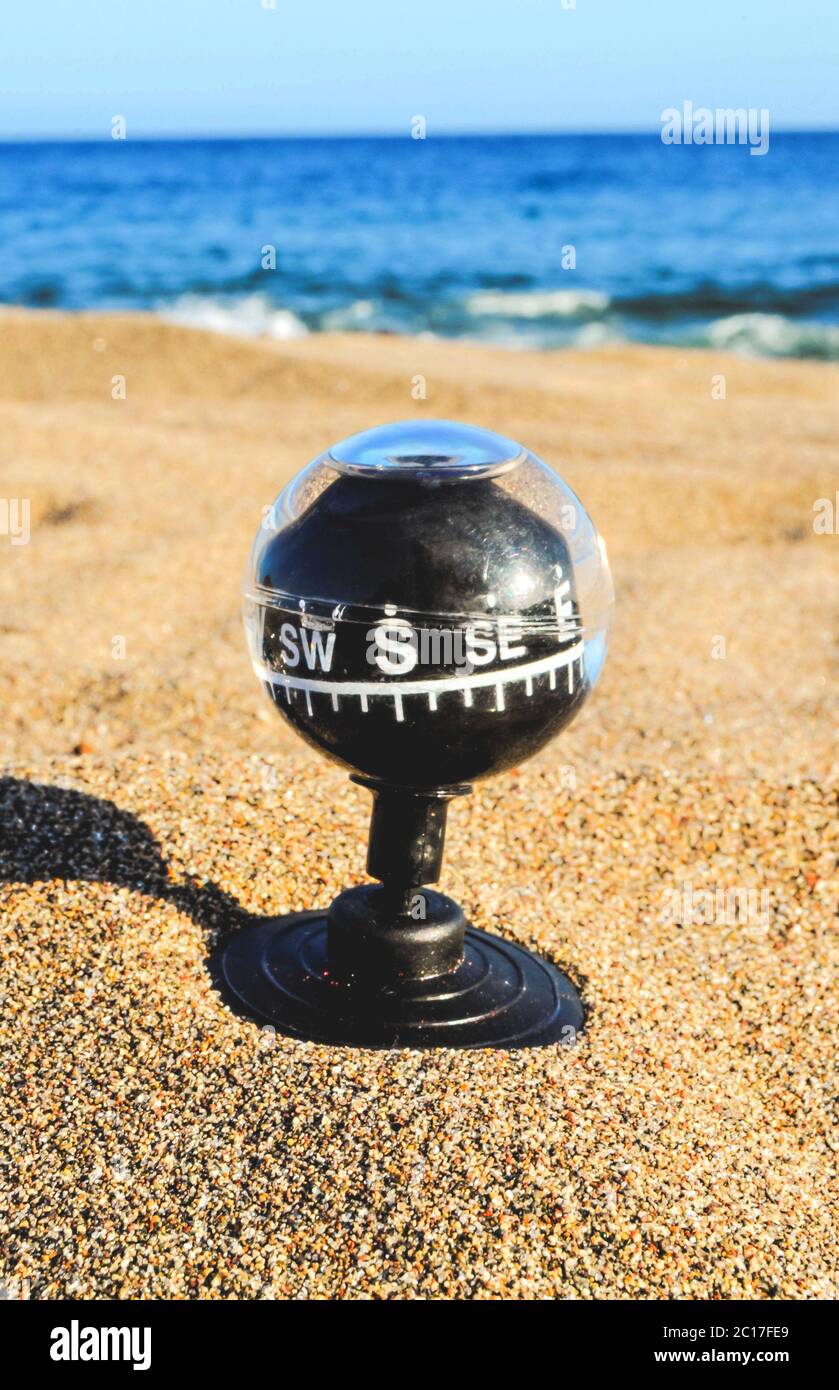 Compass on the Sand Beach Stock Photo - Alamy