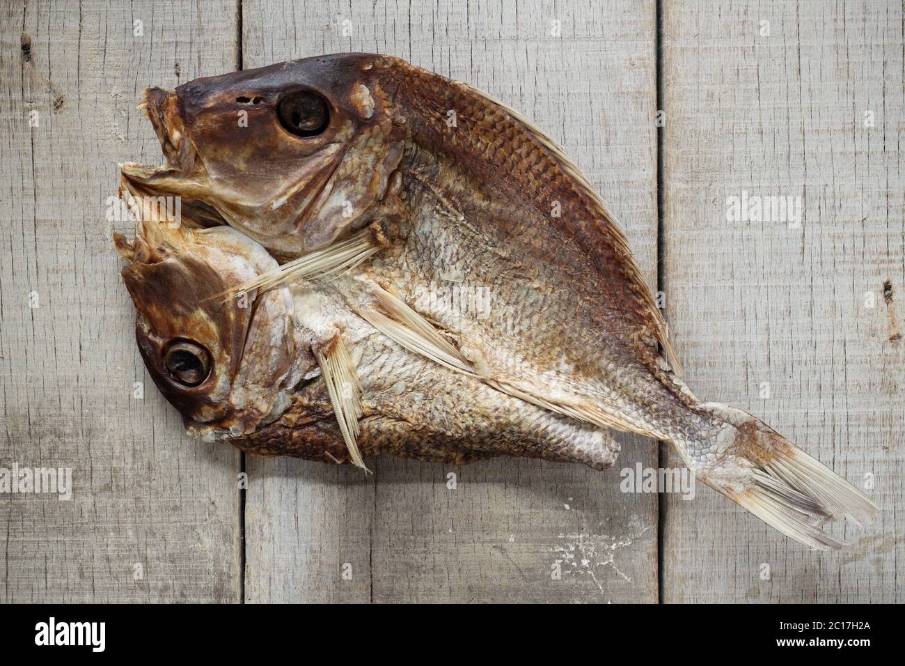 Dried fish on wooden Stock Photo - Alamy