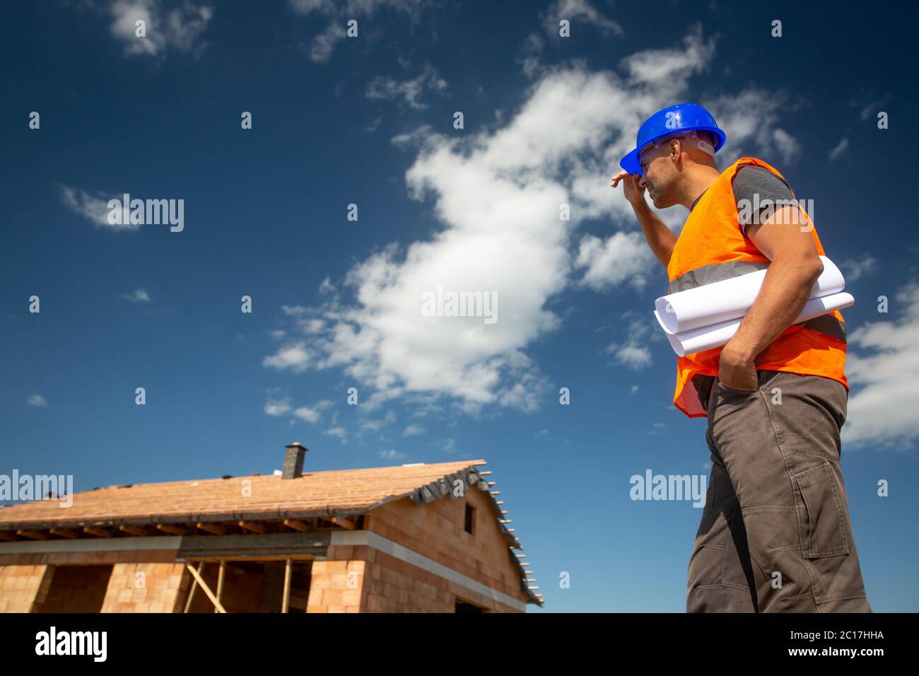 Construction or site manager overseeing the construction new building ...