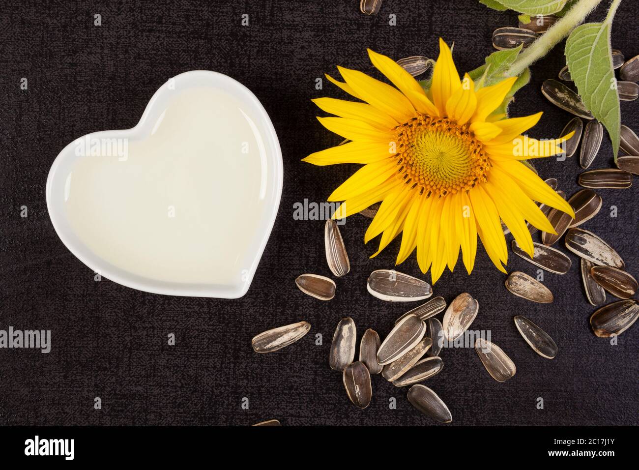 Sunflower oil, seeds and flower Stock Photo - Alamy