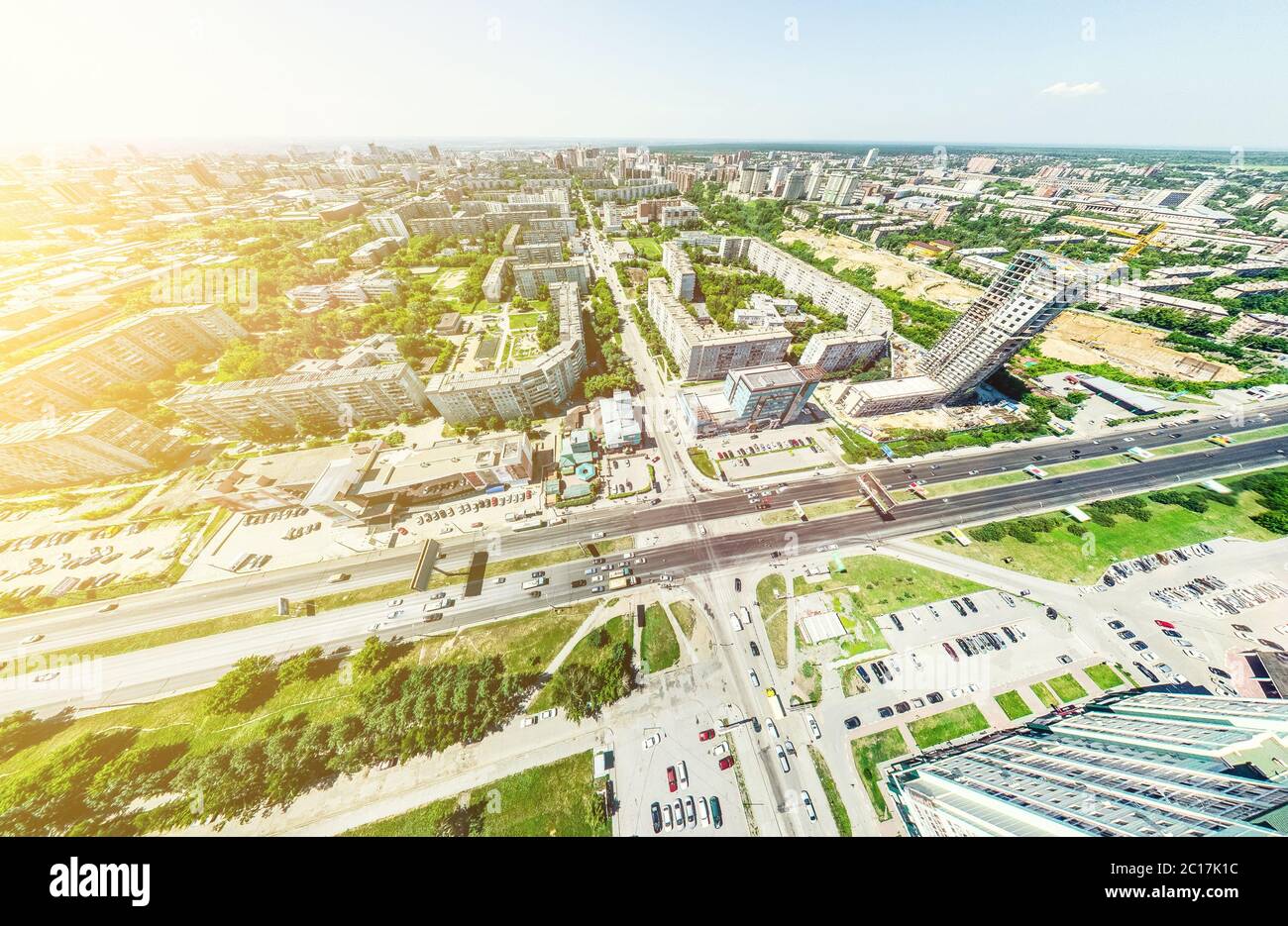 Aerial city view with crossroads and roads, houses, buildings, parks ...