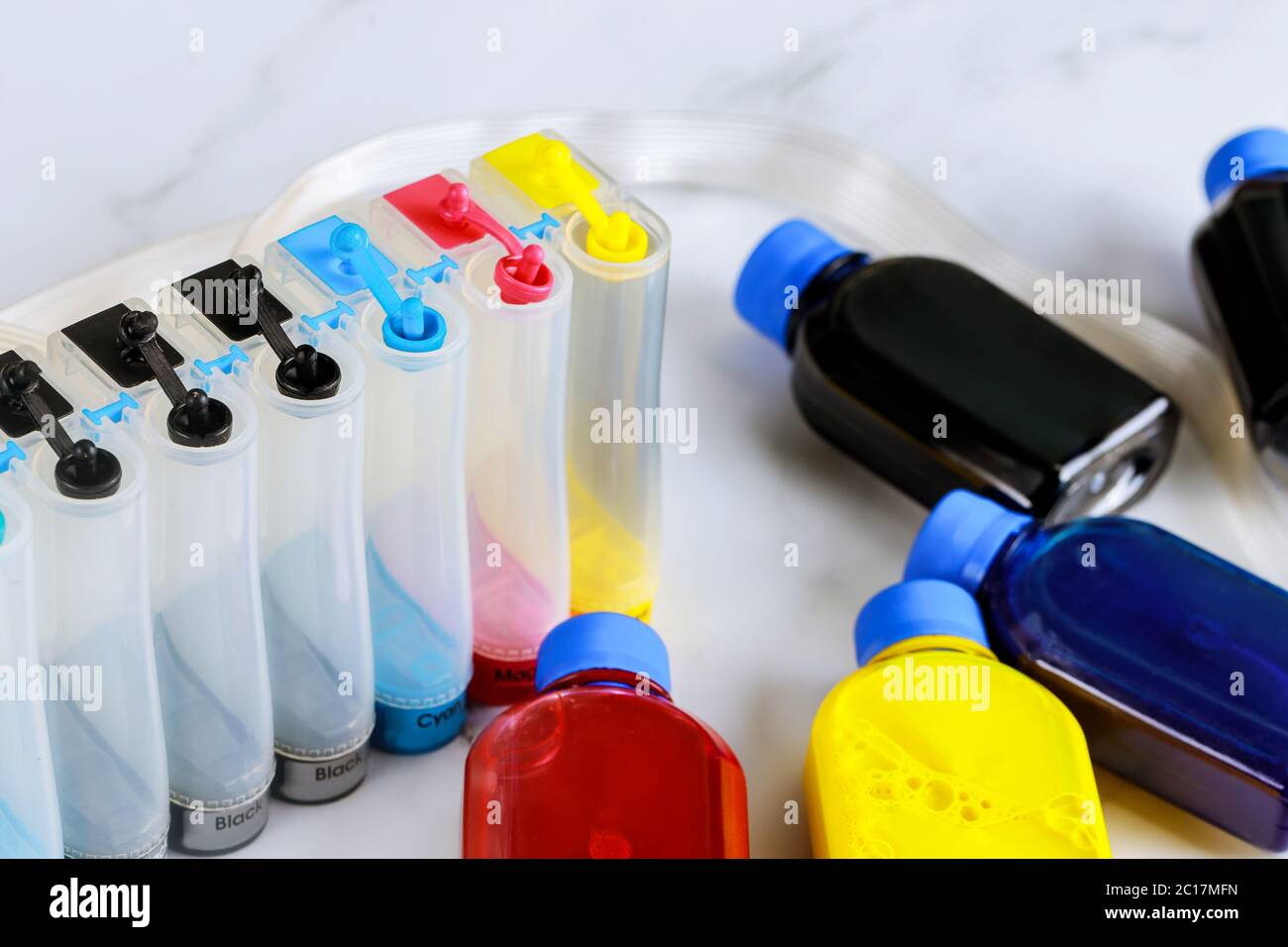 Refilling color CMYK ink tank on inkjet printer Stock Photo - Alamy